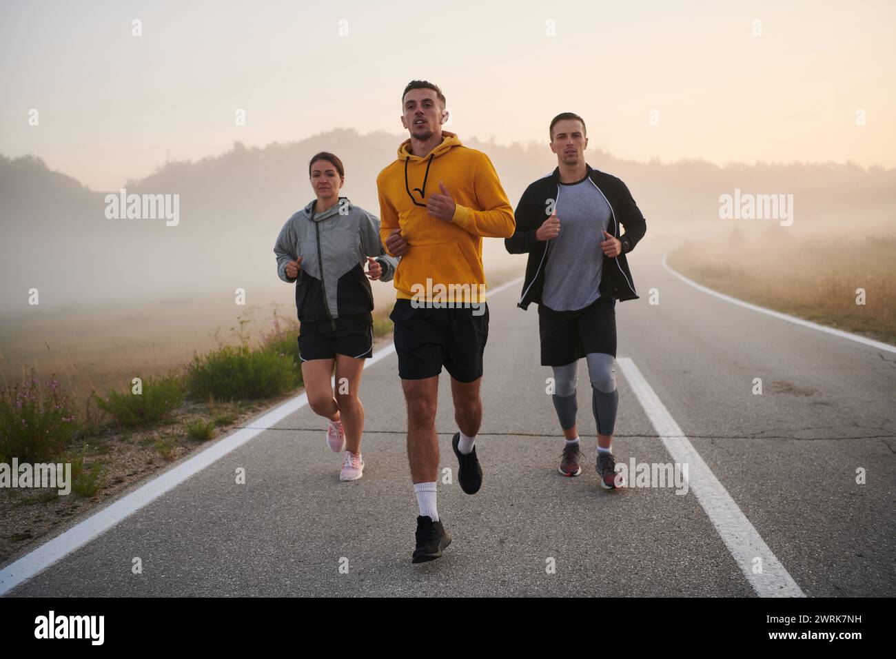 Running towards a common goal, a group of colleagues braves the misty ...