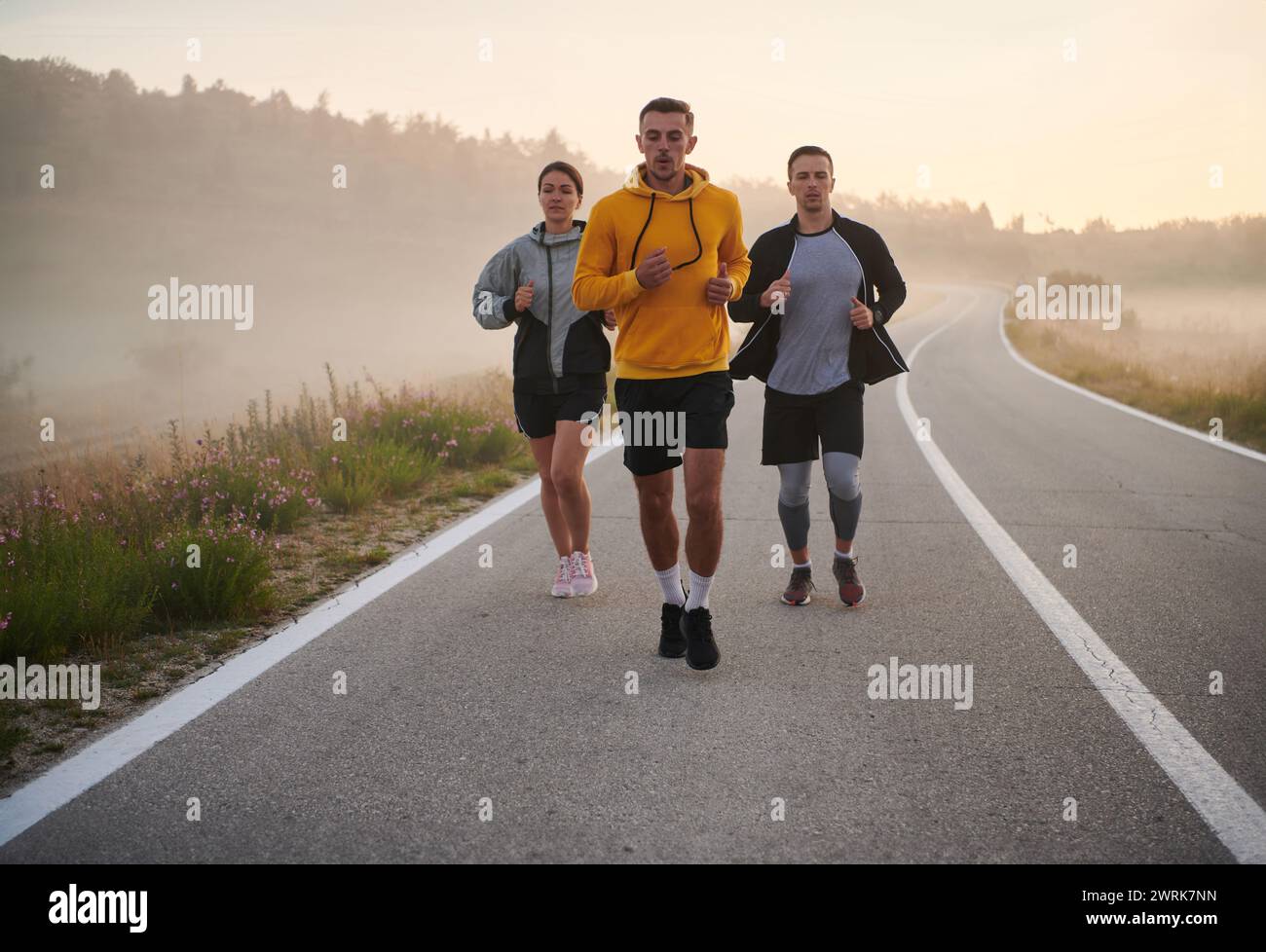 Running towards a common goal, a group of colleagues braves the misty ...