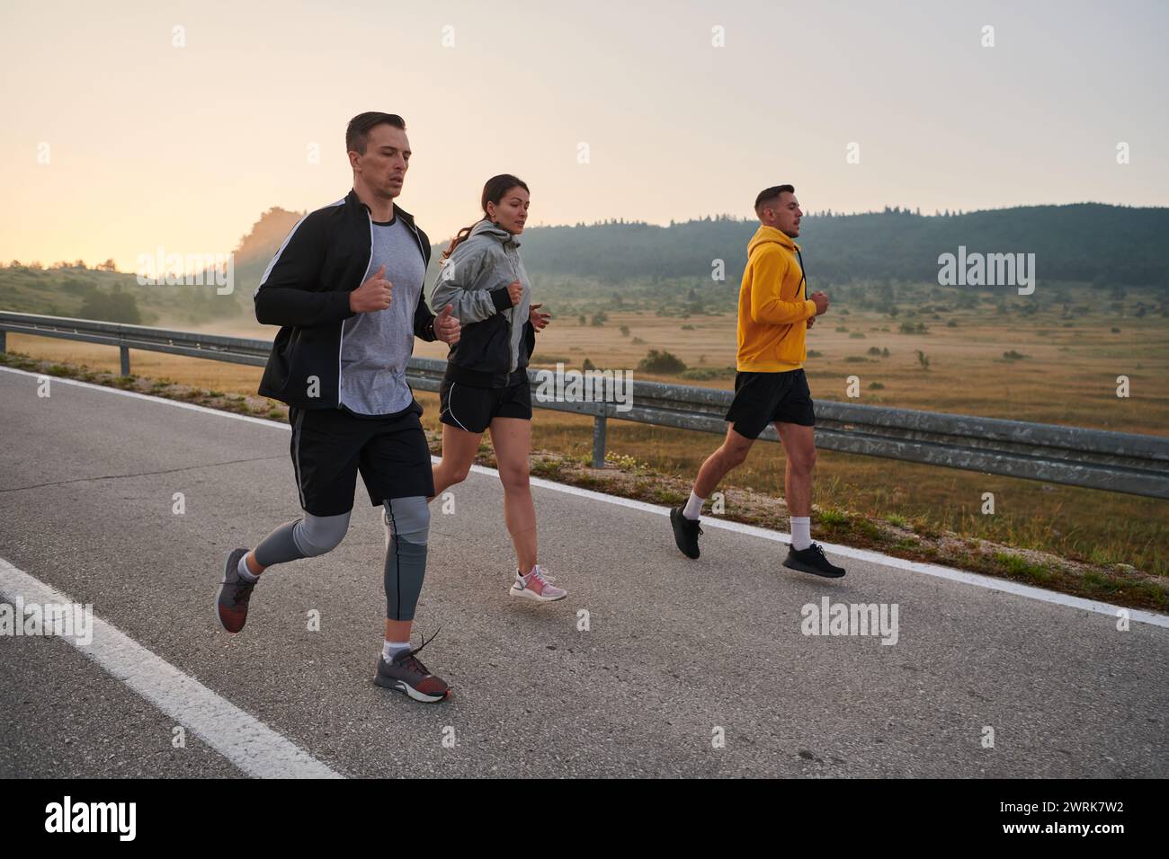 Running towards a common goal, a group of colleagues braves the misty ...