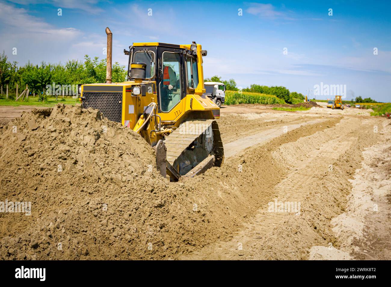 Earthmover with caterpillar is moving earth on the building site Stock ...