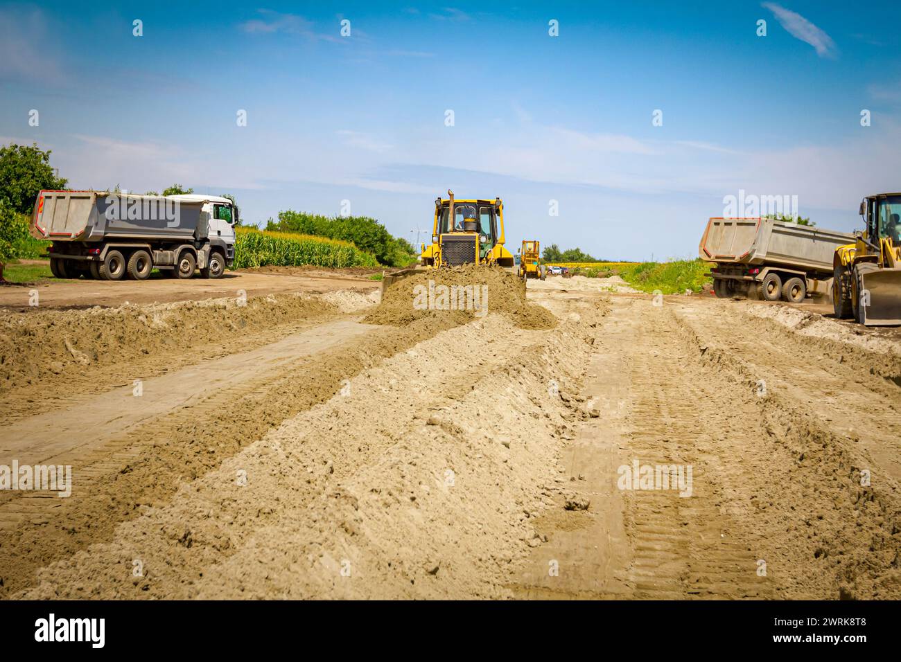 Bulldozer leveling ground during road hi-res stock photography and ...