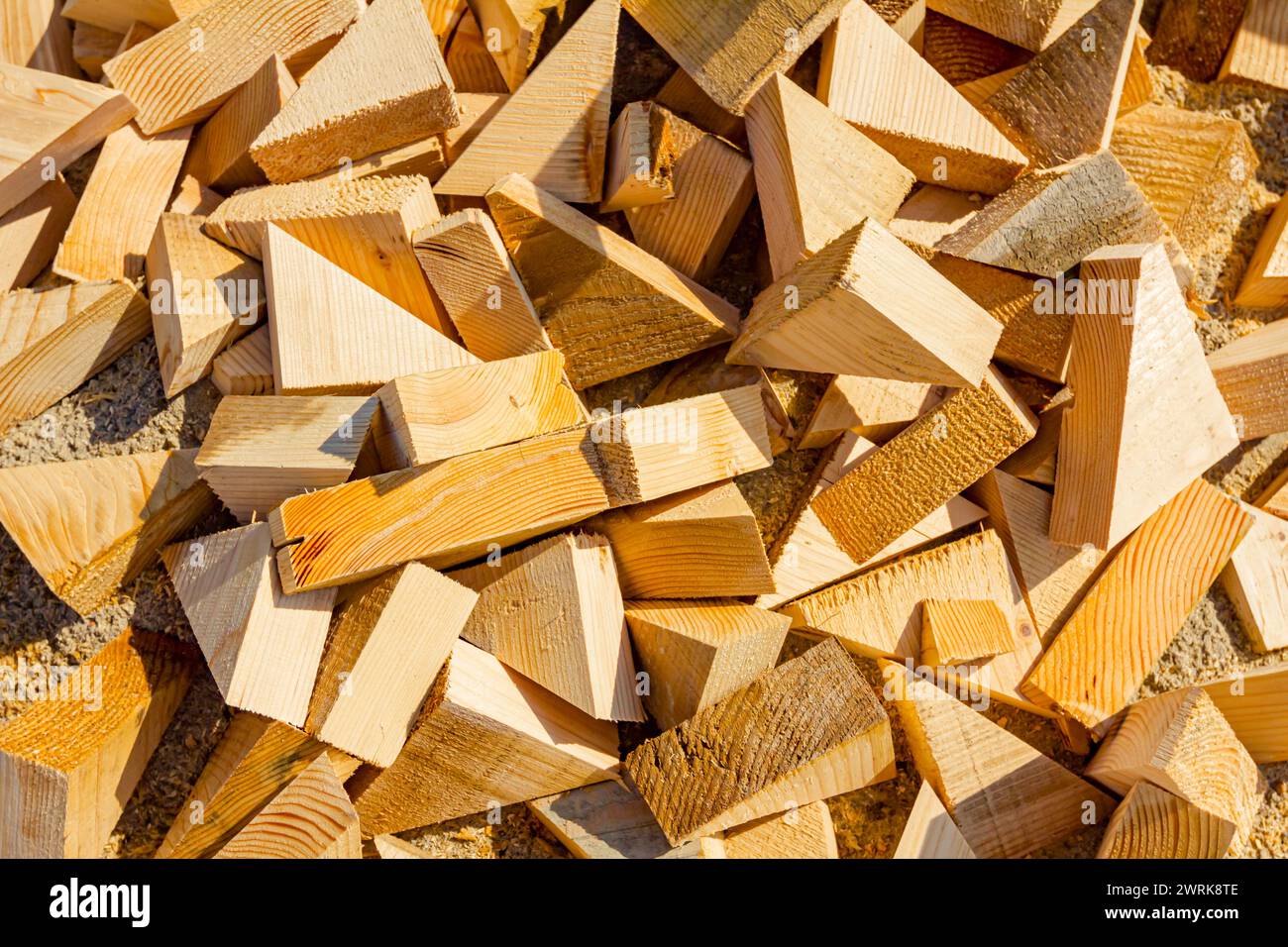 Large pile of pieces cut wood with various forms, waste of chopped tree ...