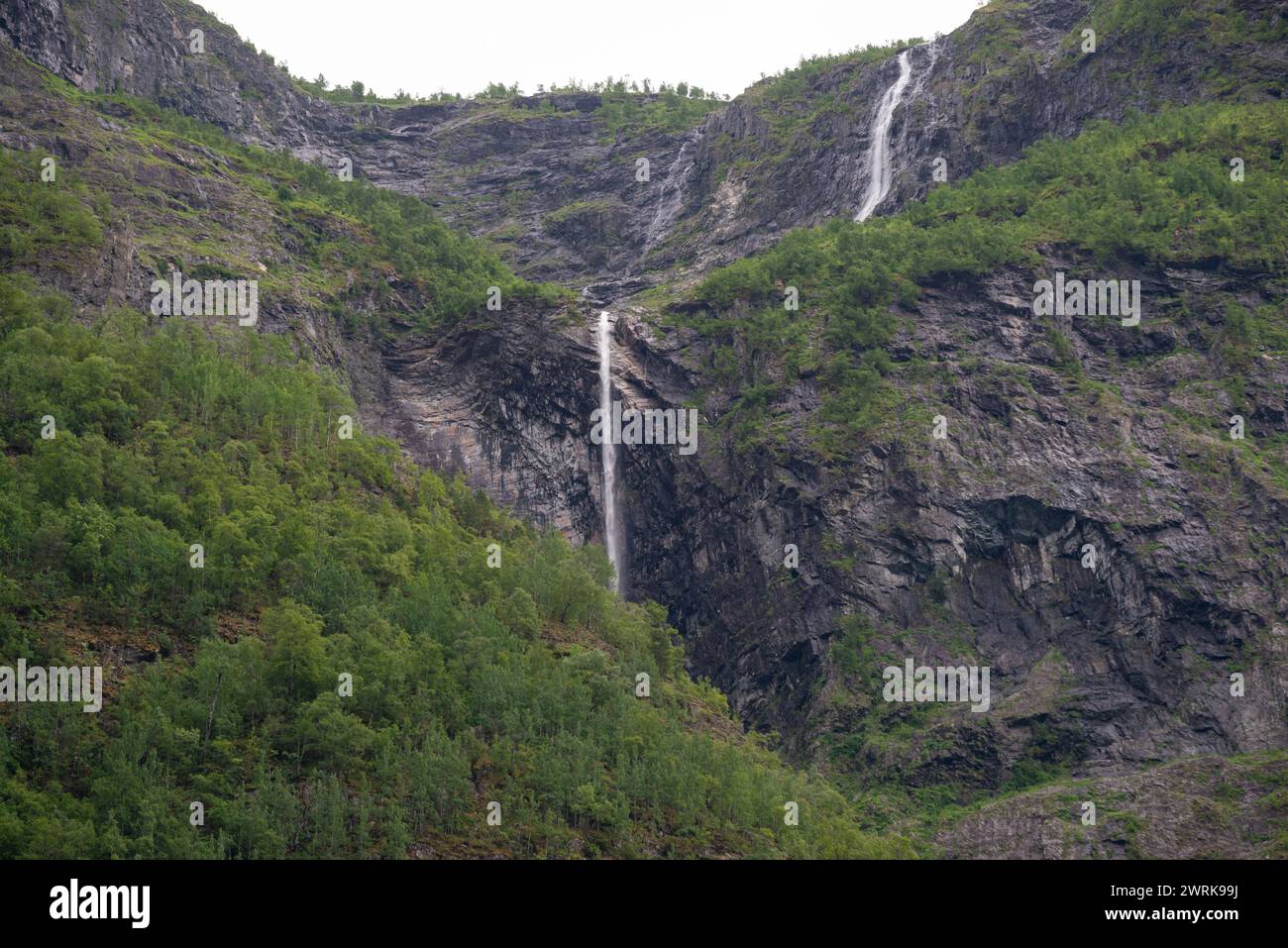 Norwegian fjord mountain nature view with waterfall and green trees ...