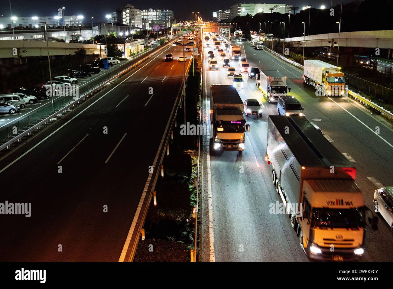 Trucks and the other vehicles drive on Metropolitan Expressway in Tokyo ...