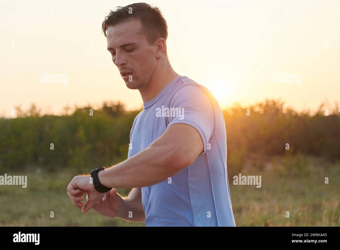Sunny Run: Athlete Checks Smartwatch While Running in the Sun Stock ...