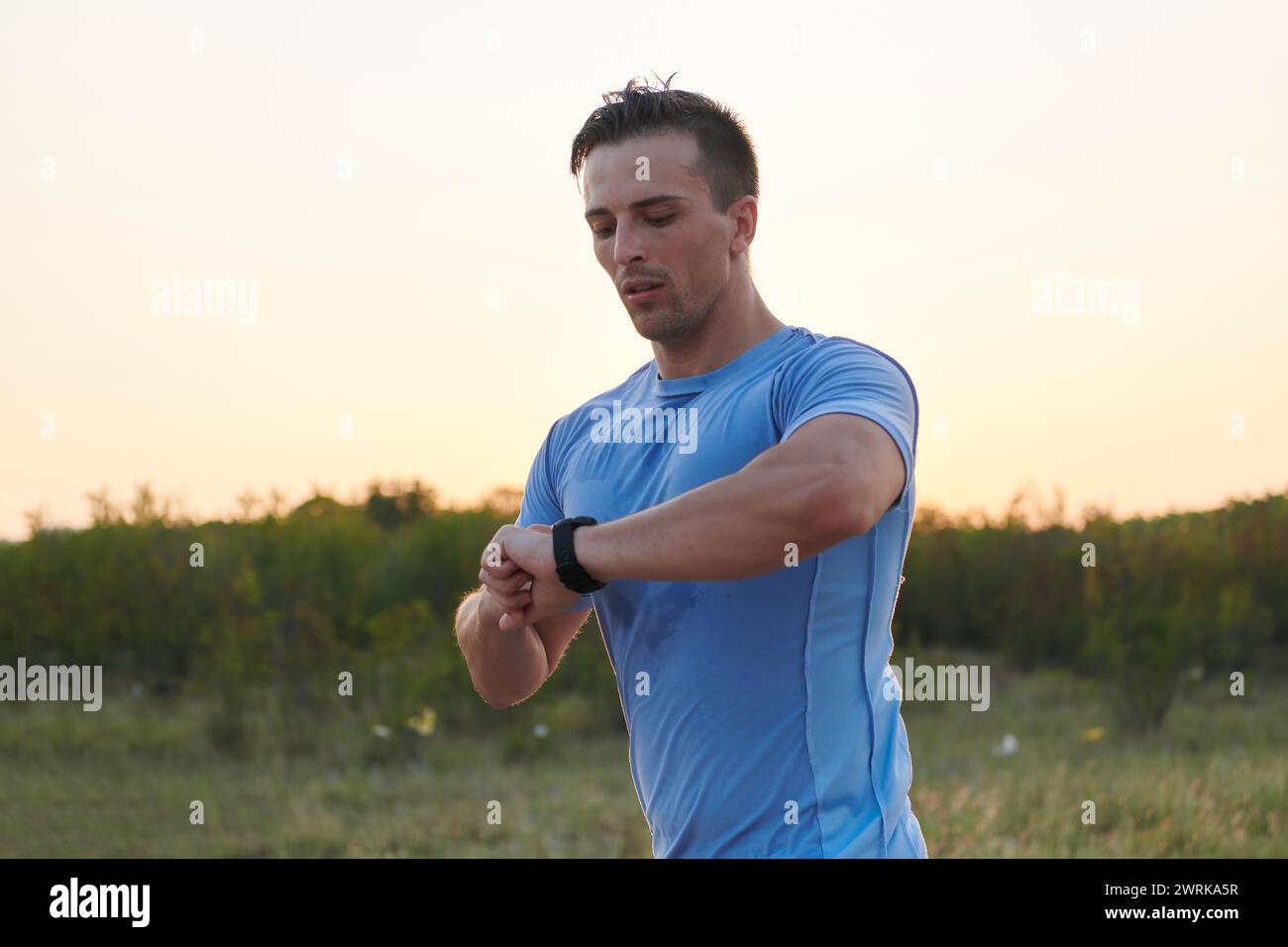 Sunny Run: Athlete Checks Smartwatch While Running in the Sun Stock ...