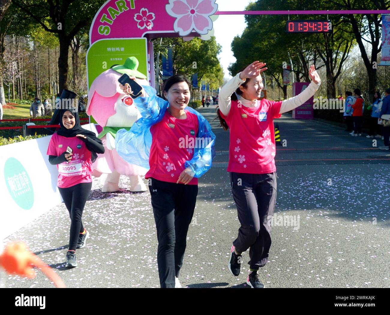 Runners participate in a women's 10km race at Gucun Park in Shanghai ...