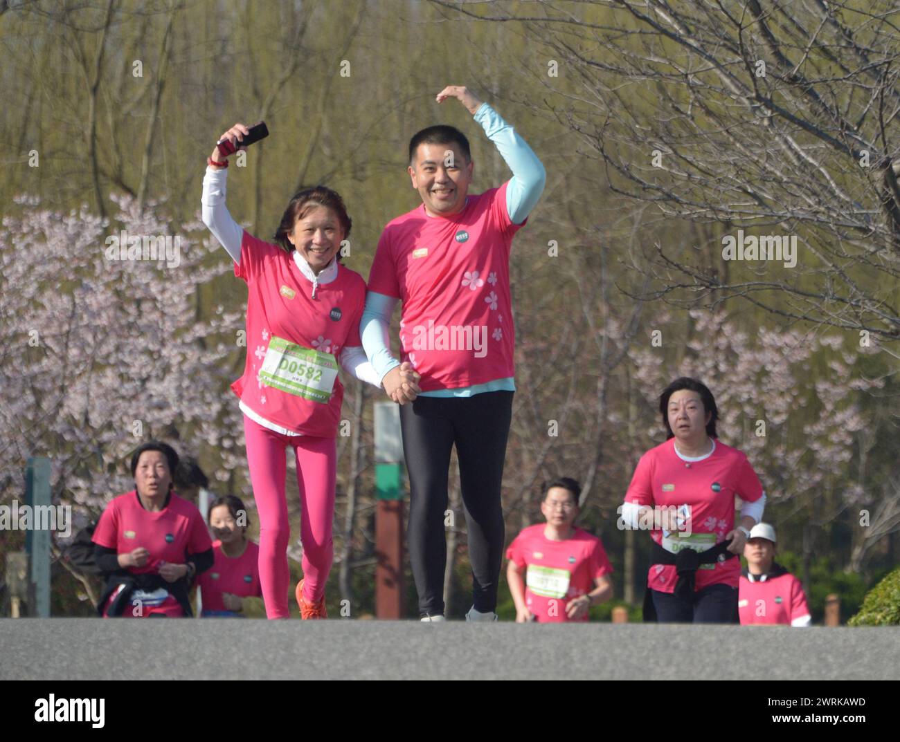 Runners participate in a women's 10km race at Gucun Park in Shanghai ...