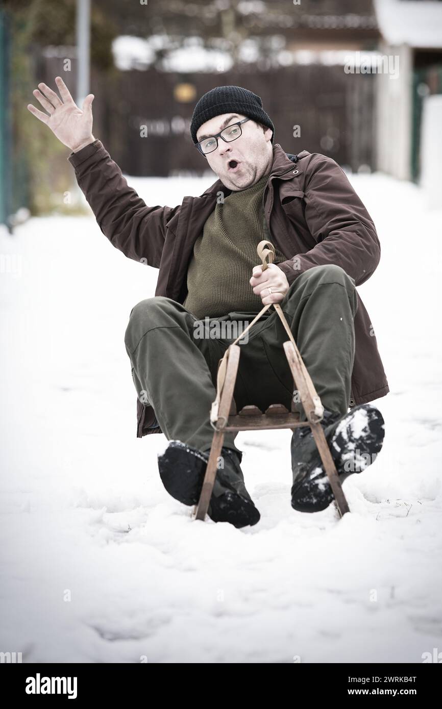 Adult man enjoying winter with classic retro wooden toboggan Stock ...