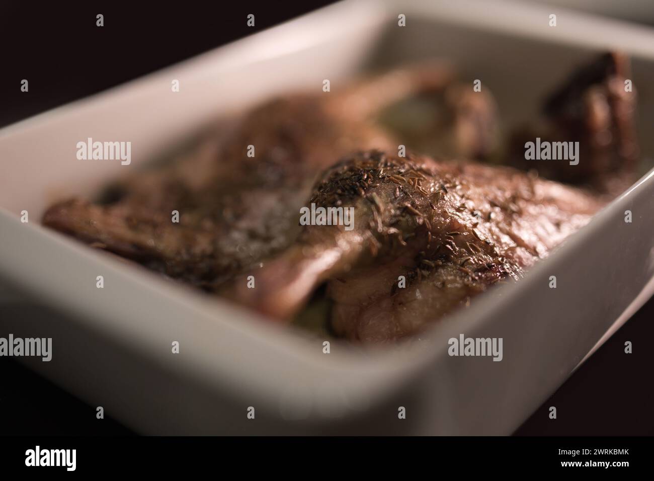 Well done fresh duck thighs baked slow time in oven Stock Photo - Alamy