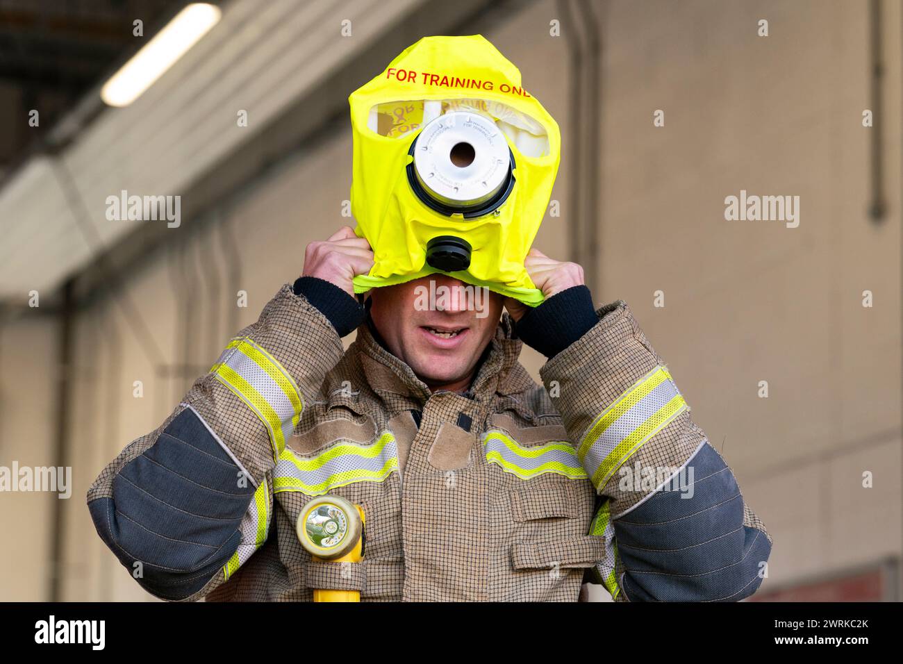 A London Fire Brigade firefighter operates new fire escape hoods during ...