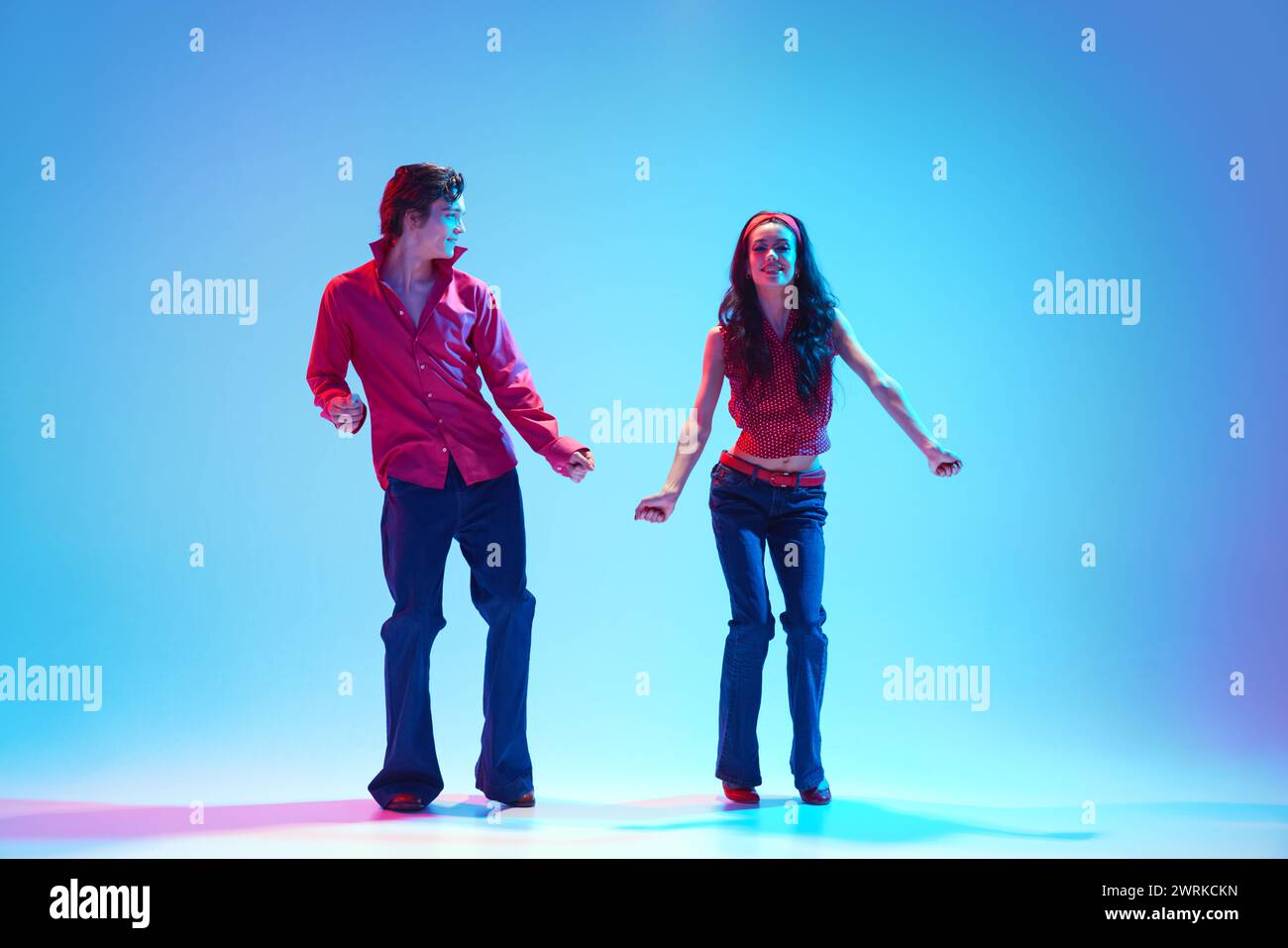 Stylish handsome young man and beautiful woman dancing rock and roll ...