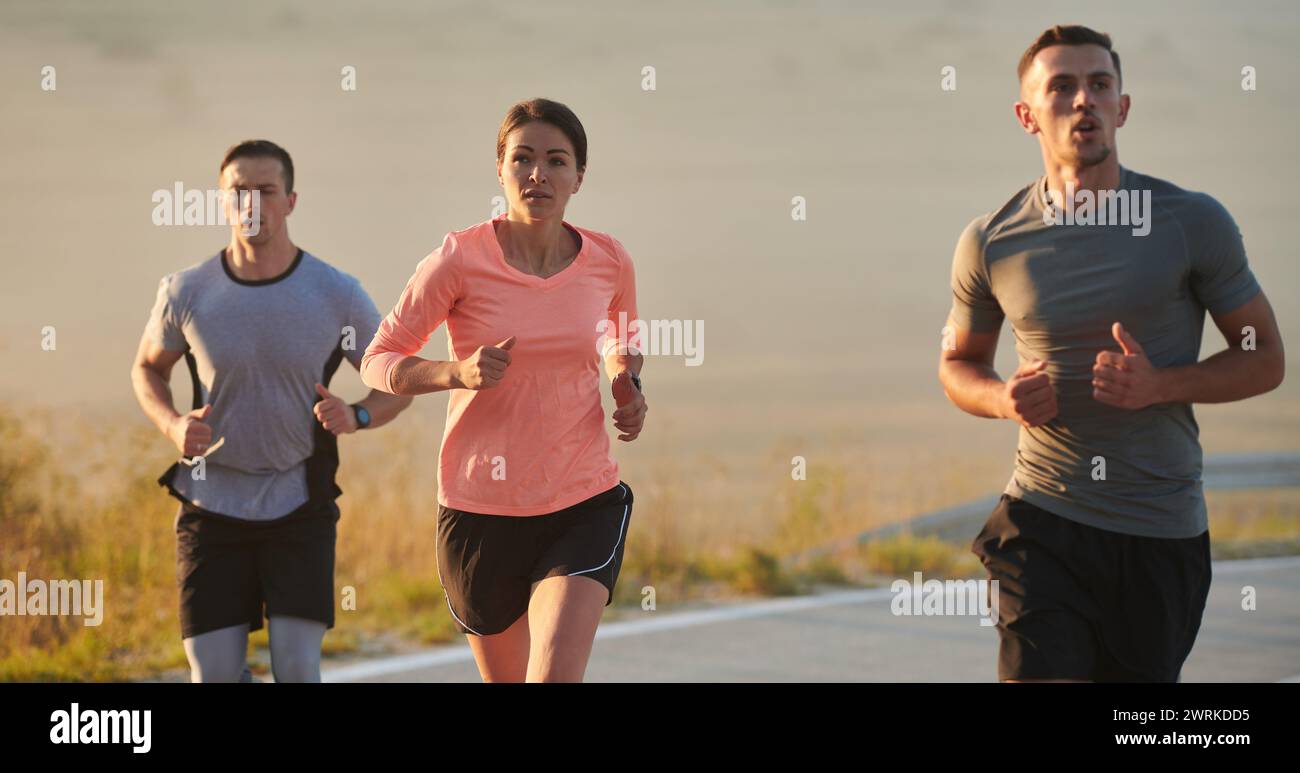 A group of friends, athletes, and joggers embrace the early morning ...