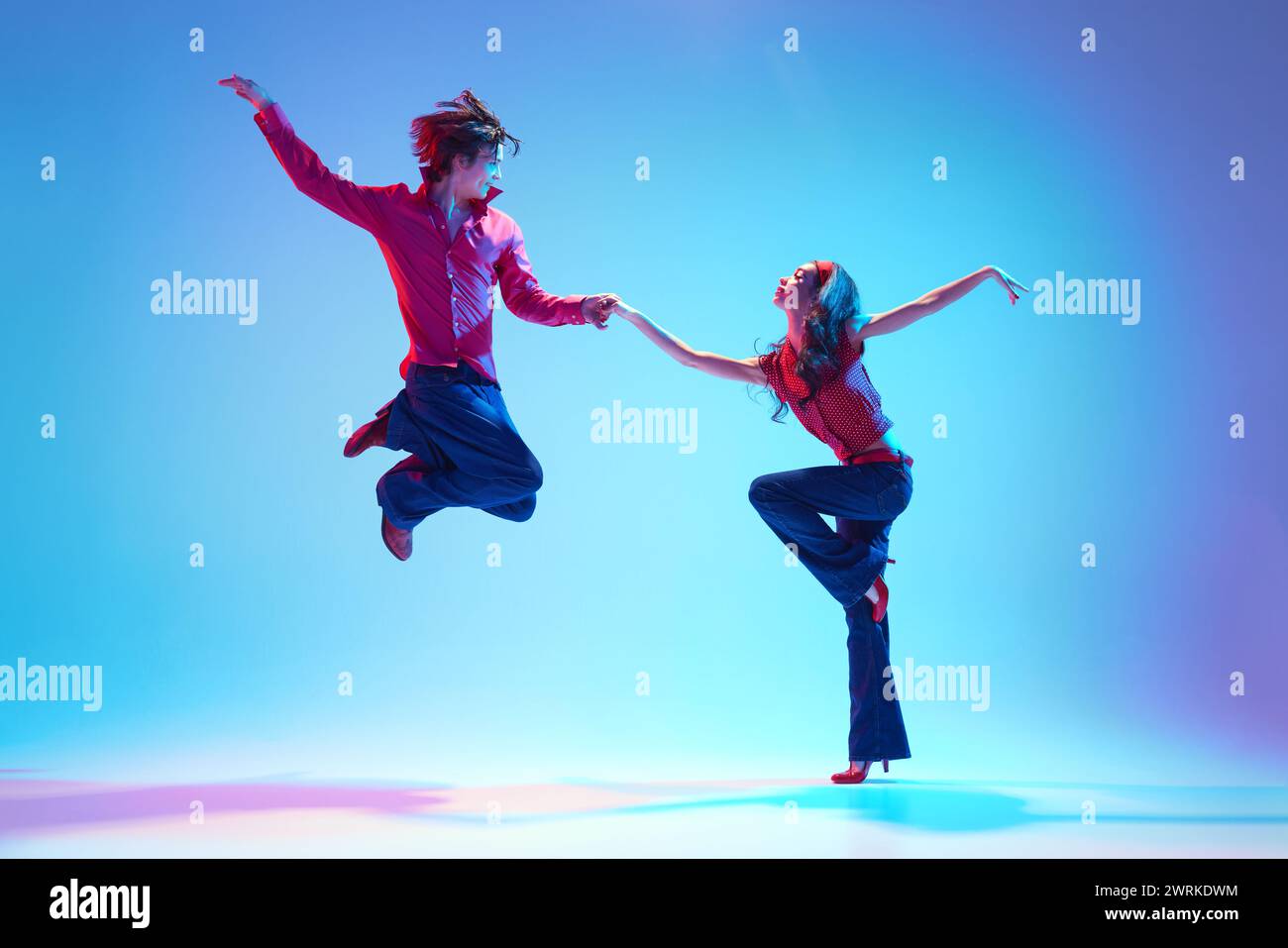 Stylish handsome young man and beautiful woman dancing rock and roll ...