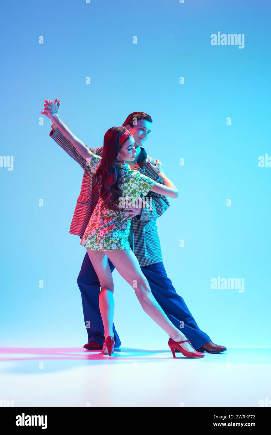 Beautiful, stylish, elegant young couple, man and woman dancing retro ...