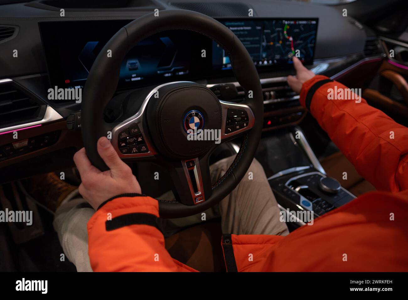 close-up man in car driving BMW i4 five-door electric liftback class D ...
