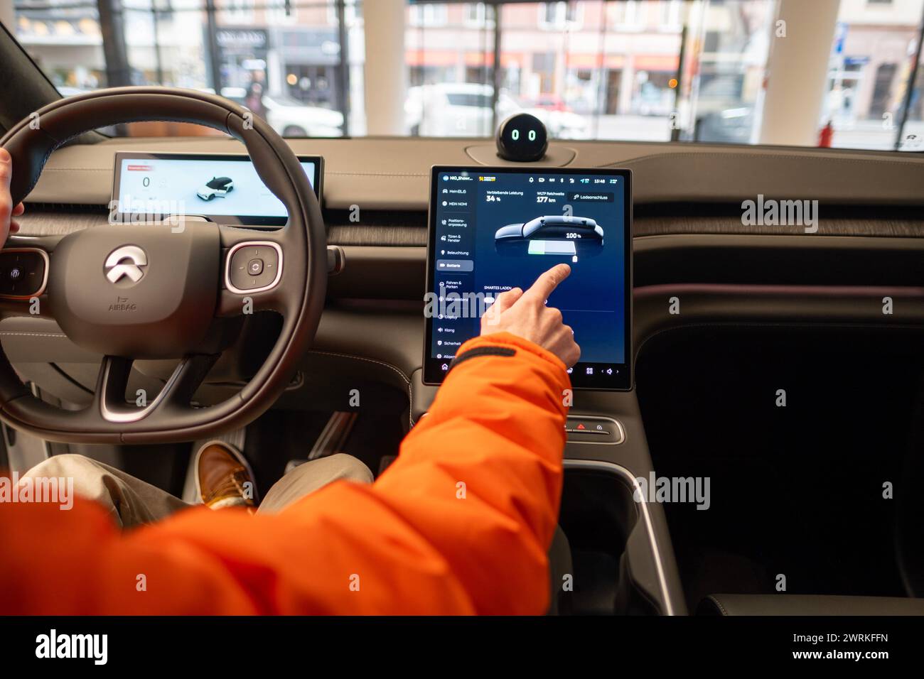 close-up male driver's hand manipulates on electronic display, steering ...