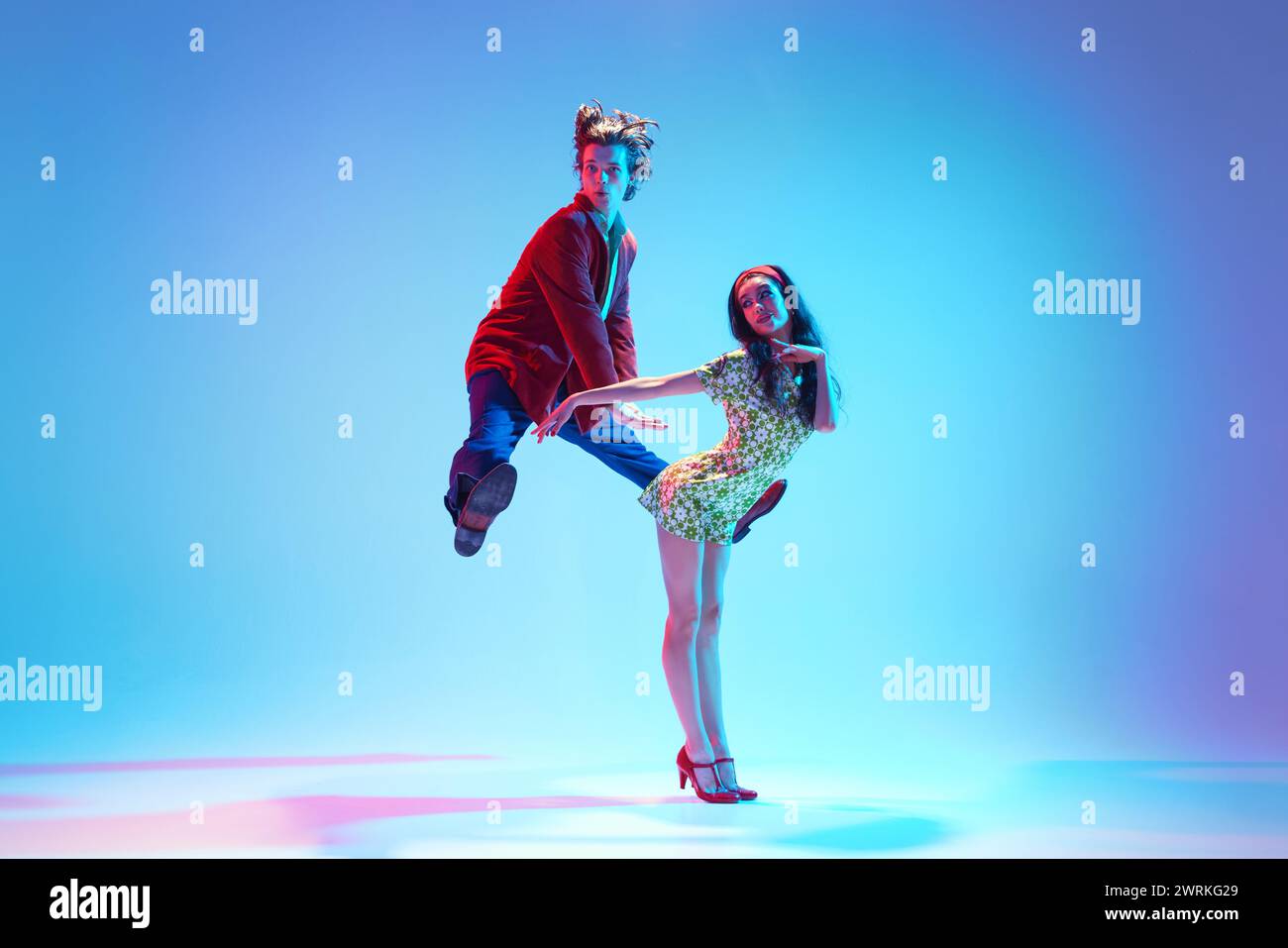 Dynamic image of young artistic couple dancing retro dance, performing ...