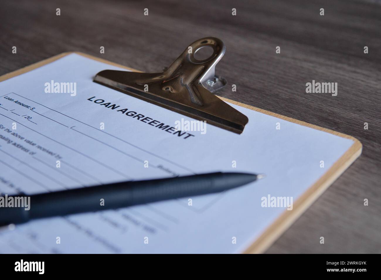 Pen and loan agreement form on a clipboard, preparation for filling and ...
