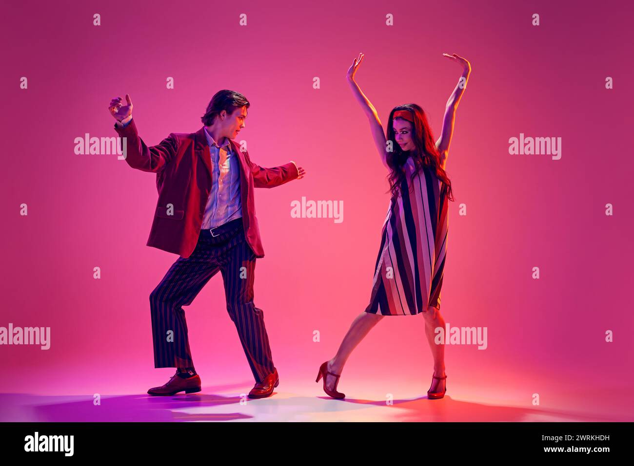 Young man and woman in stylish clothes dancing retro dance, boogie ...