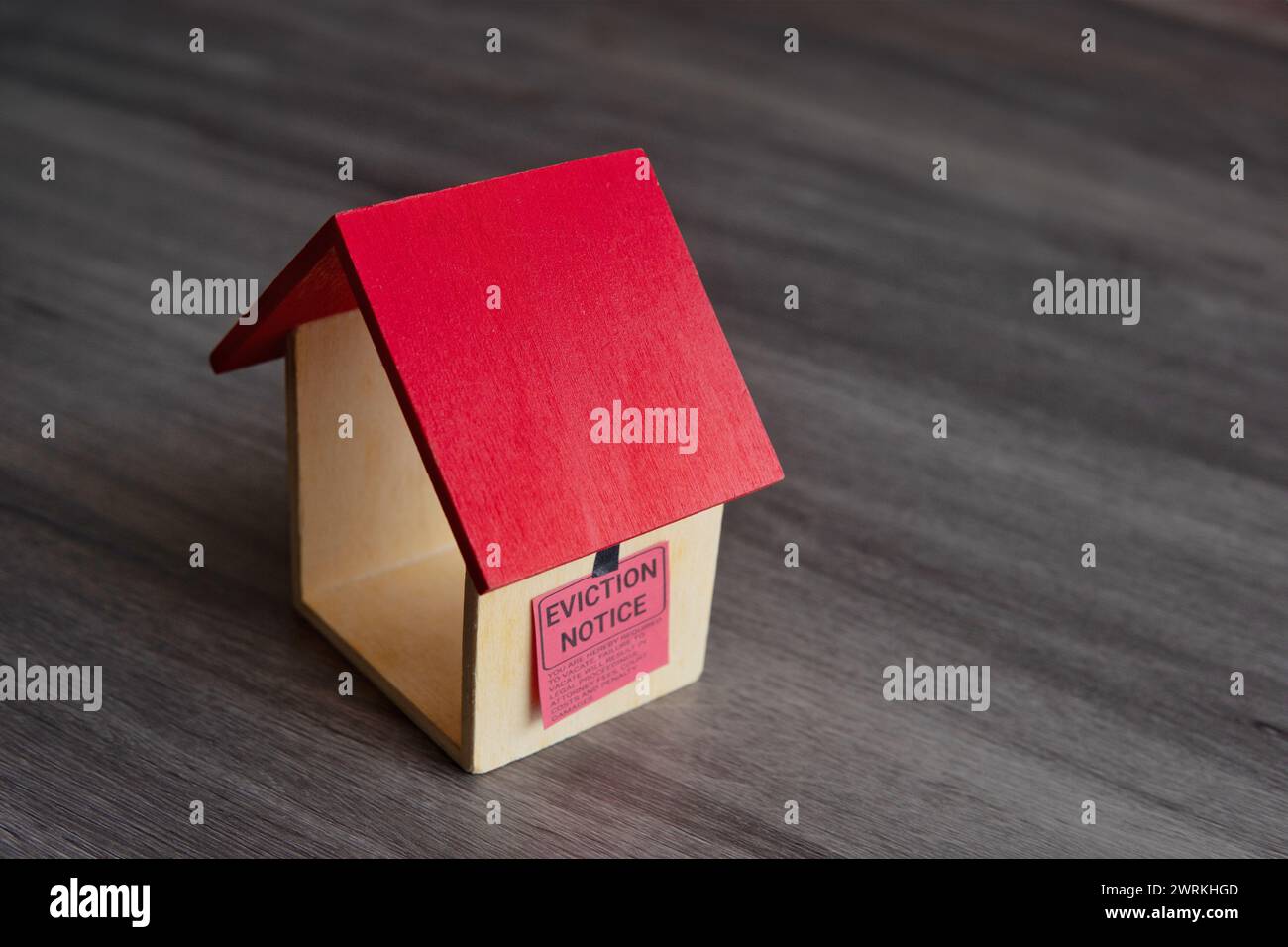 Closeup image of toy house and eviction notice Stock Photo - Alamy