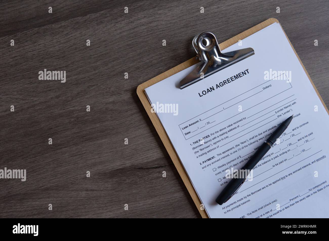 Pen and loan agreement form on a clipboard, preparation for filling and ...