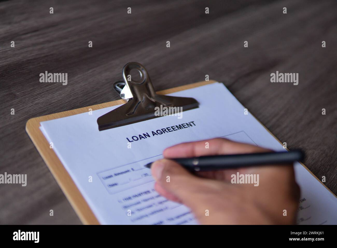 Pen and loan agreement form on a clipboard, preparation for filling and ...