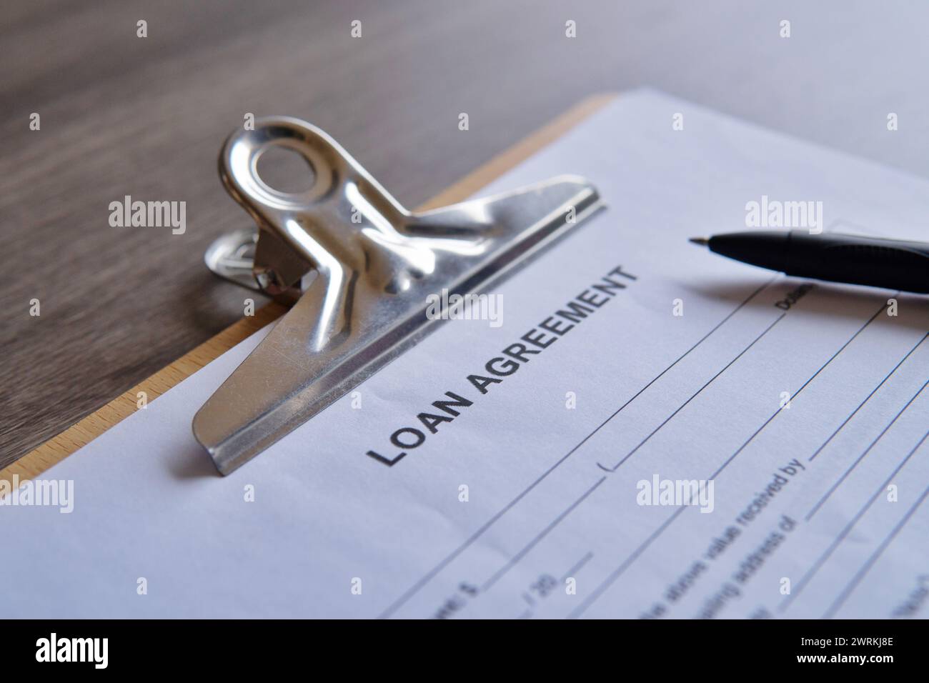 Pen and loan agreement form on a clipboard, preparation for filling and ...