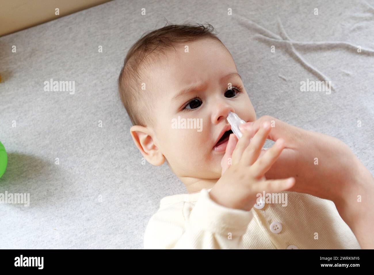 Mother dripping nasal drops for her son. Baby healthcare concept top ...