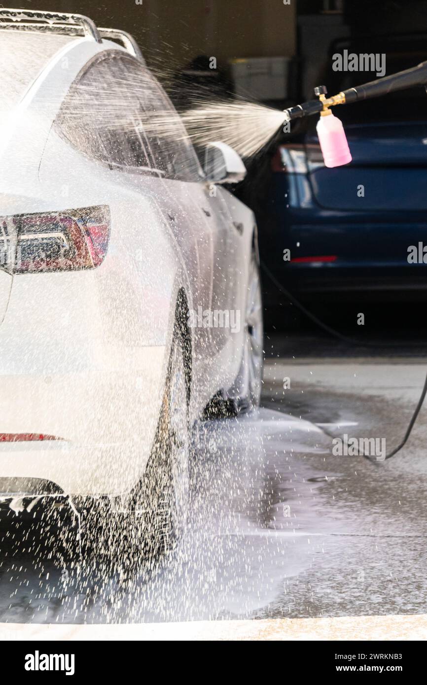 Eco-Friendly Cleaning: Washing an Electric Car at Home Stock Photo - Alamy
