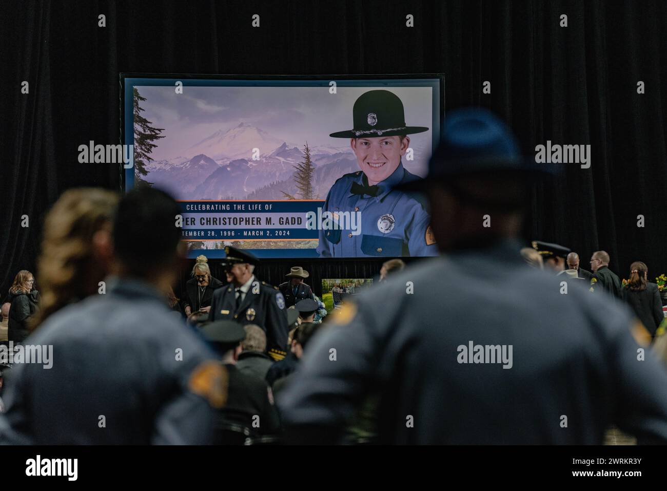 Members of the Washington State Patrol pay their respects with a somber ...
