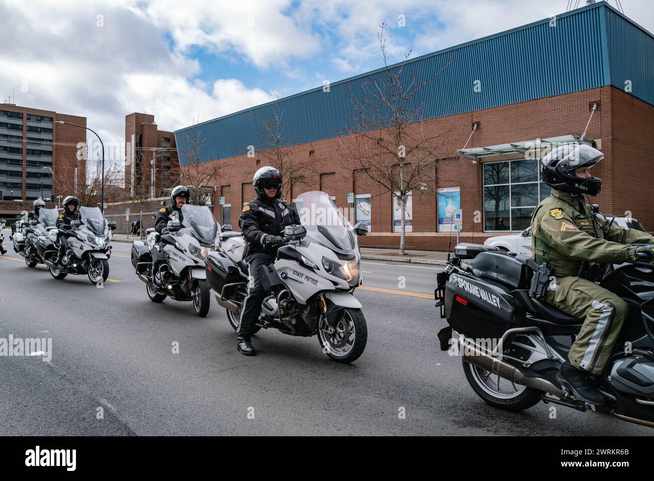 Washington State Patrol officers on motorcycles lead a solemn ...