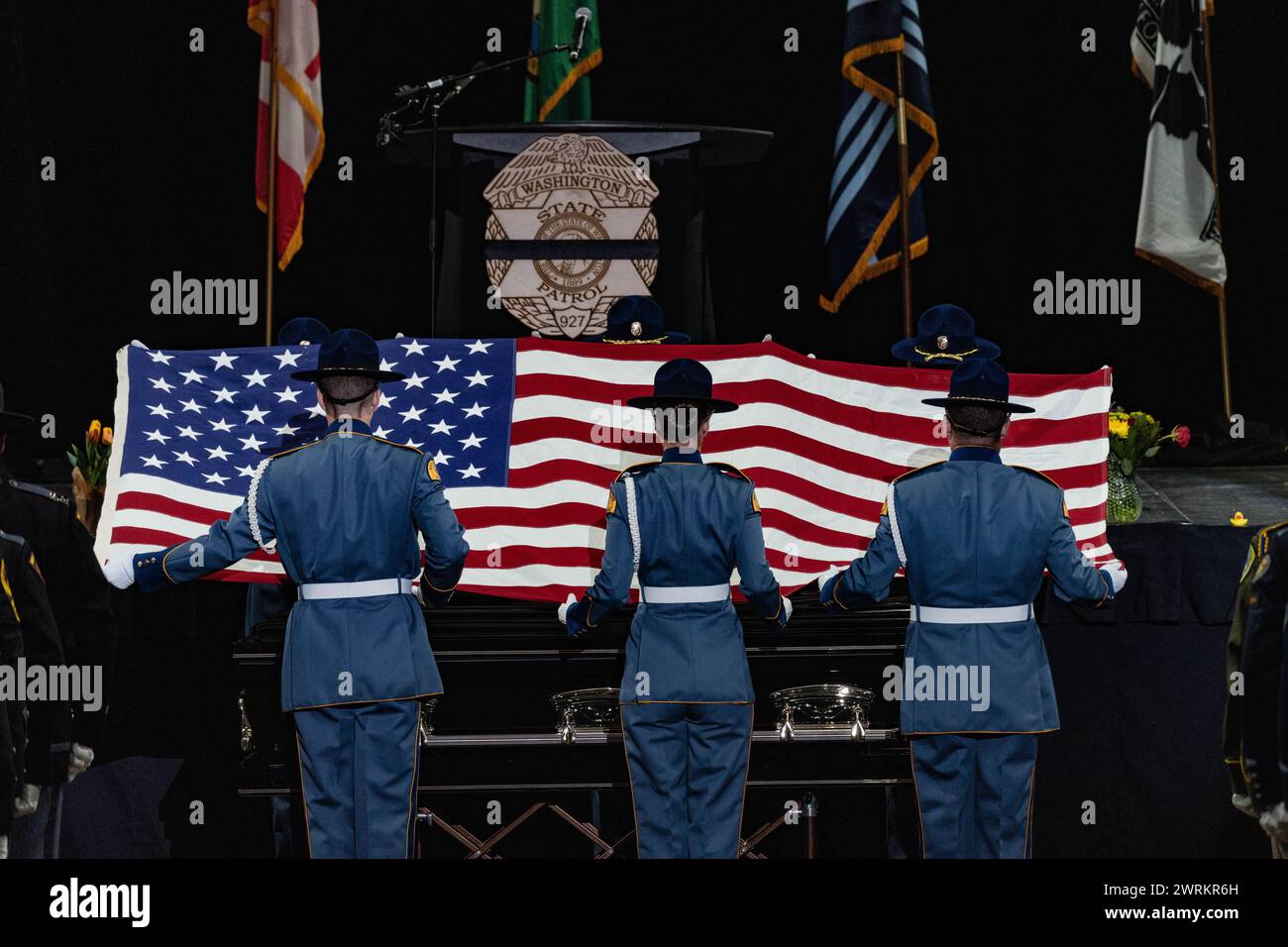Members of the Washington State Patrol pay their respects with a somber ...