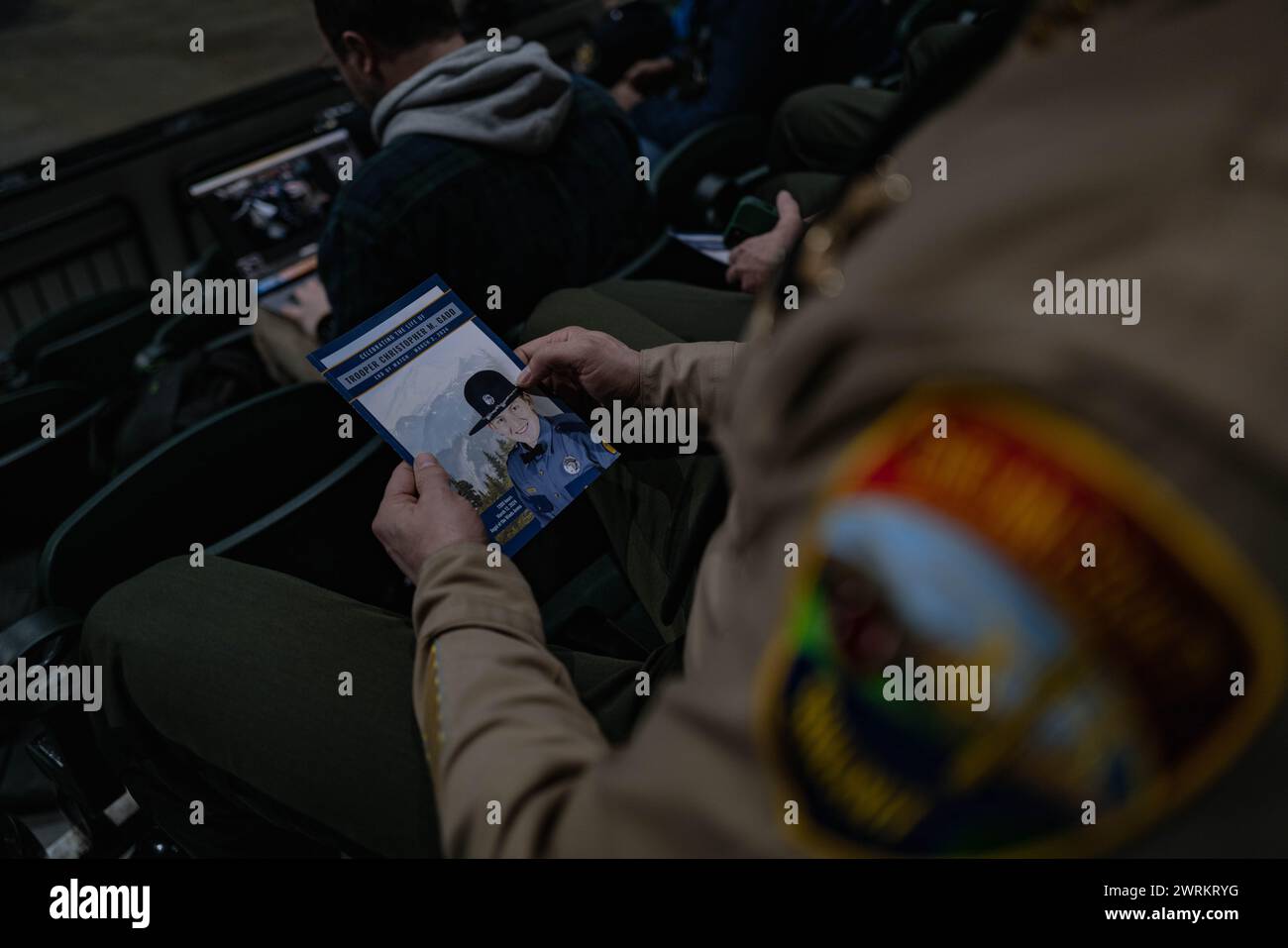 A trooper holds a poster of Washington State Patrol trooper Chris Gadd ...