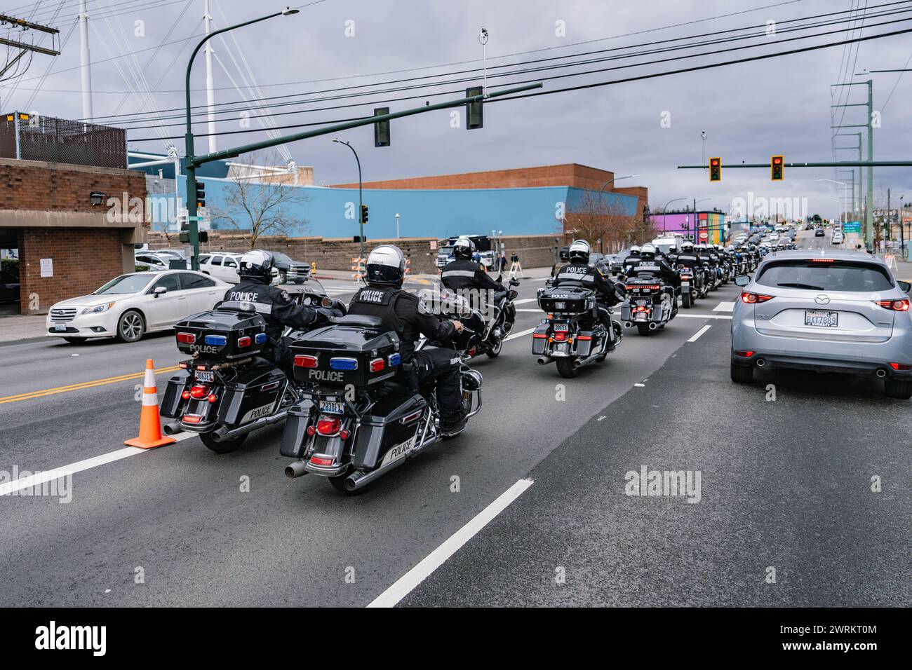 Washington State Patrol officers on motorcycles lead a solemn ...