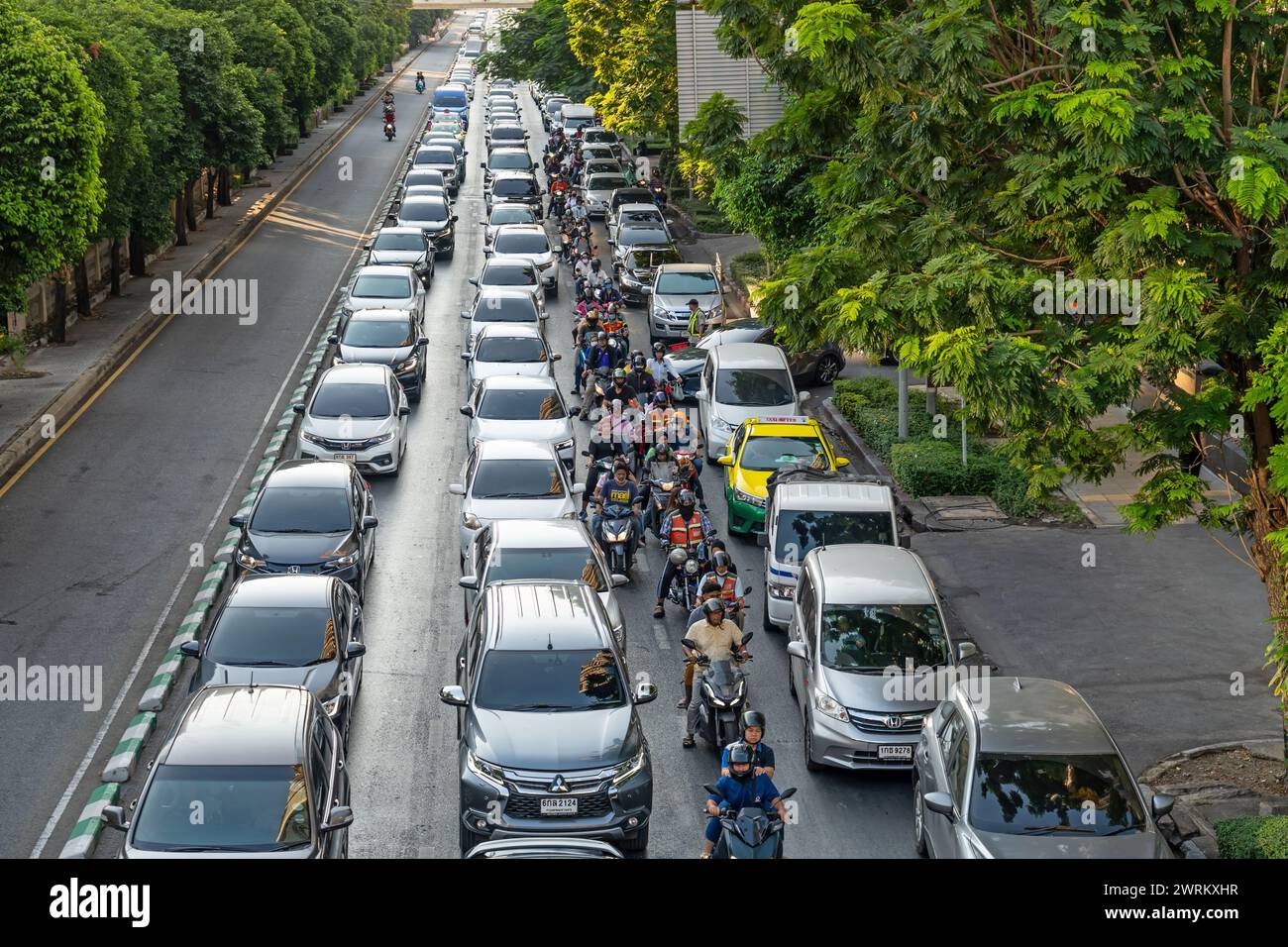 Traffic moves slowly along a busy road cowded traffic jam road in city ...