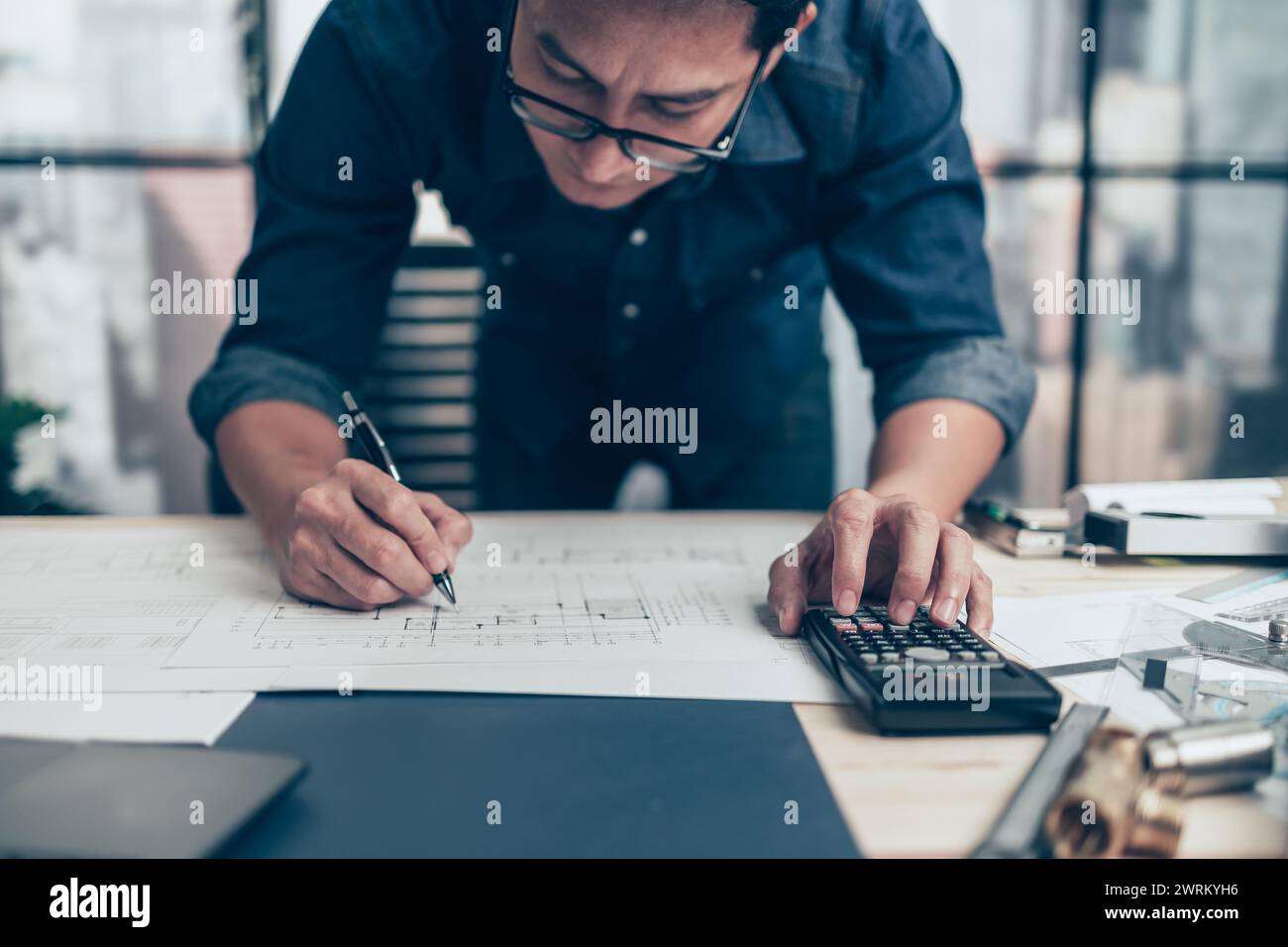 Architect engineer use calculator for calculate drawing design working ...