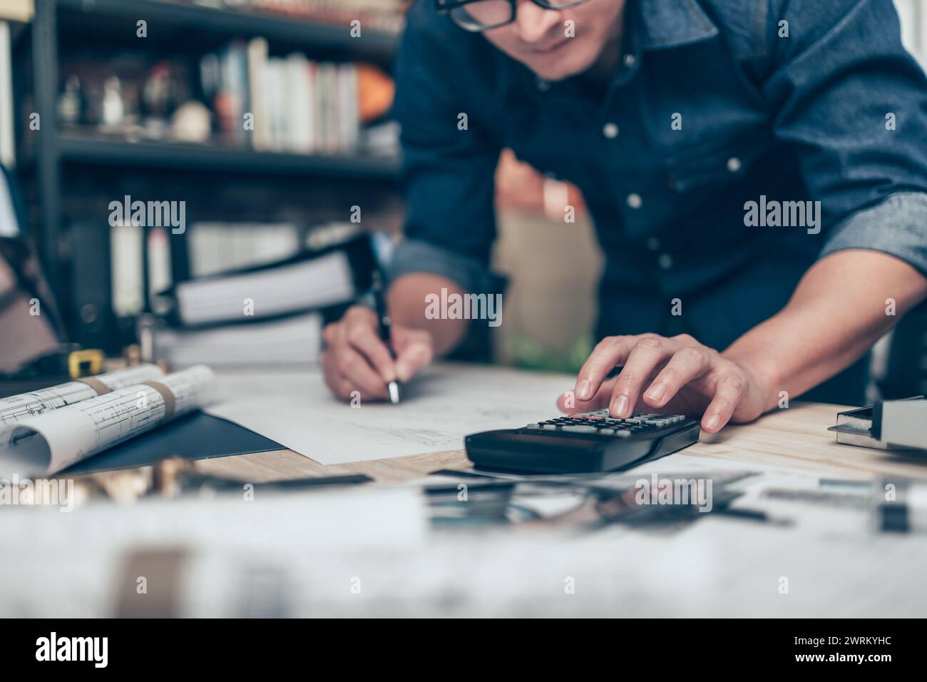 Architect engineer use calculator for calculate drawing design working ...