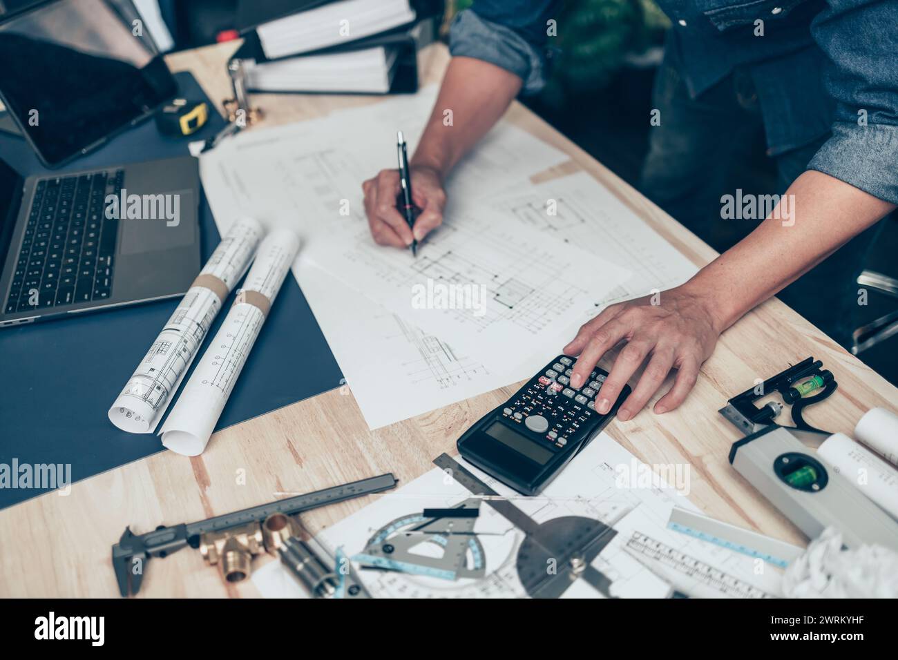 Architect engineer use calculator for calculate drawing design working ...