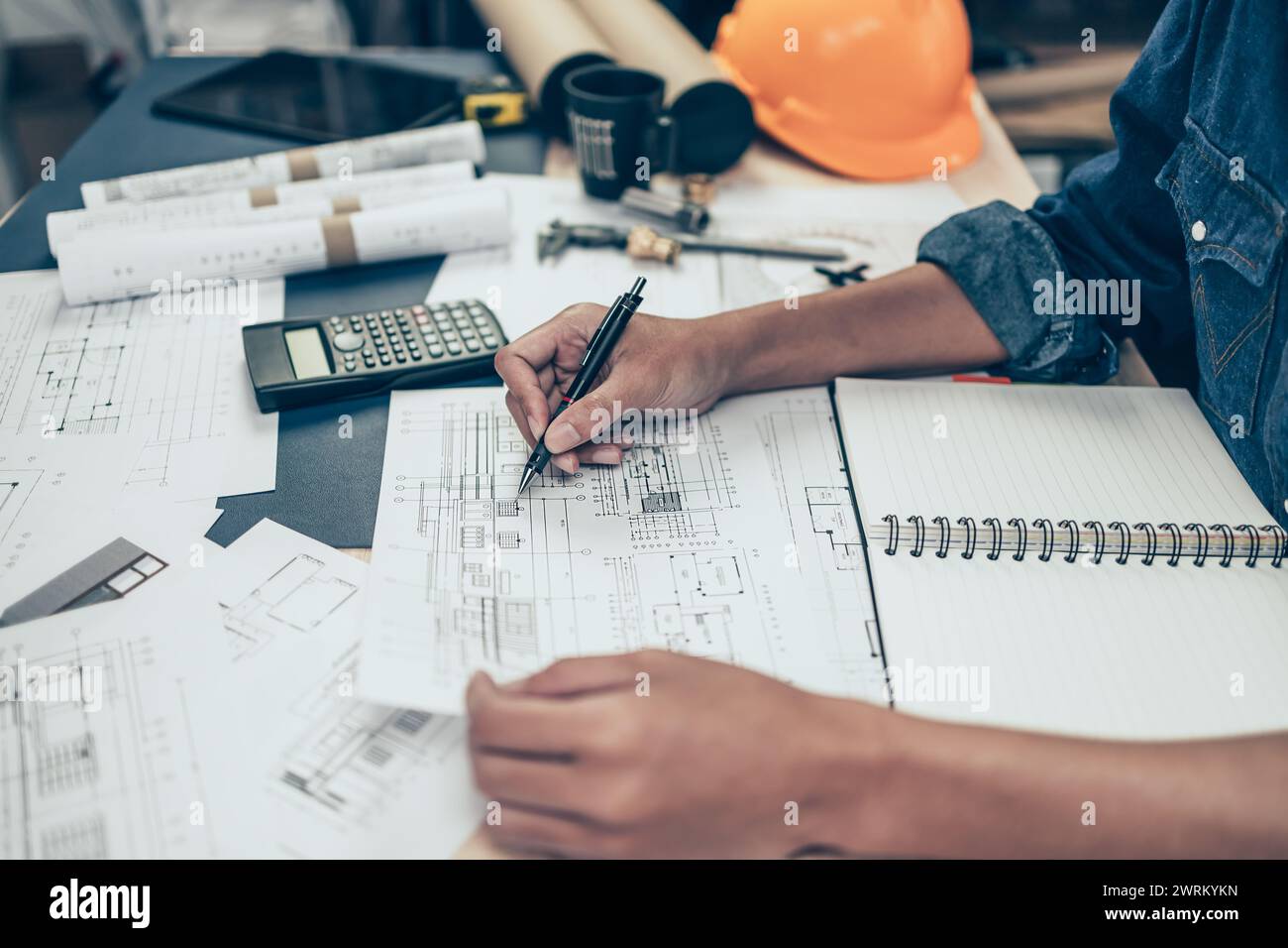 Architect engineer use pen drawing design working on blueprint. House ...