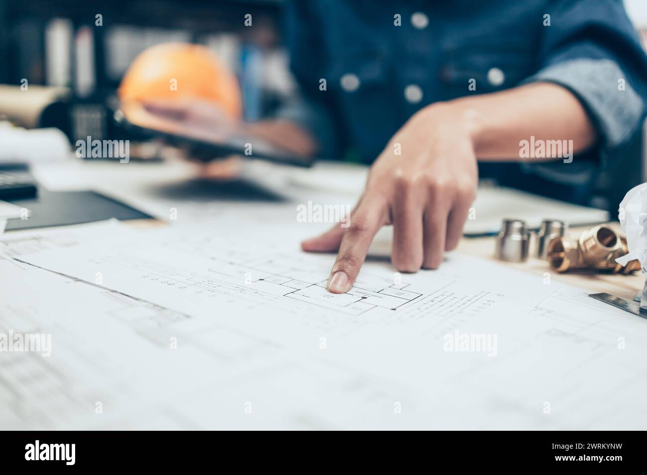 Architect engineer use pen drawing design and finger point to check ...