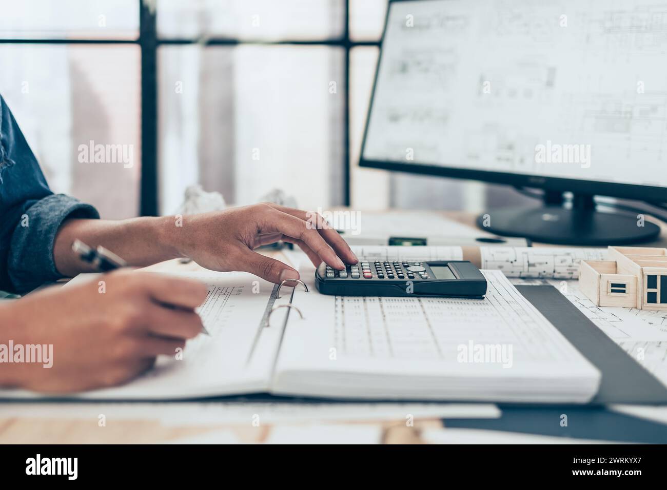 Architect engineer use calculator for calculate drawing design working ...