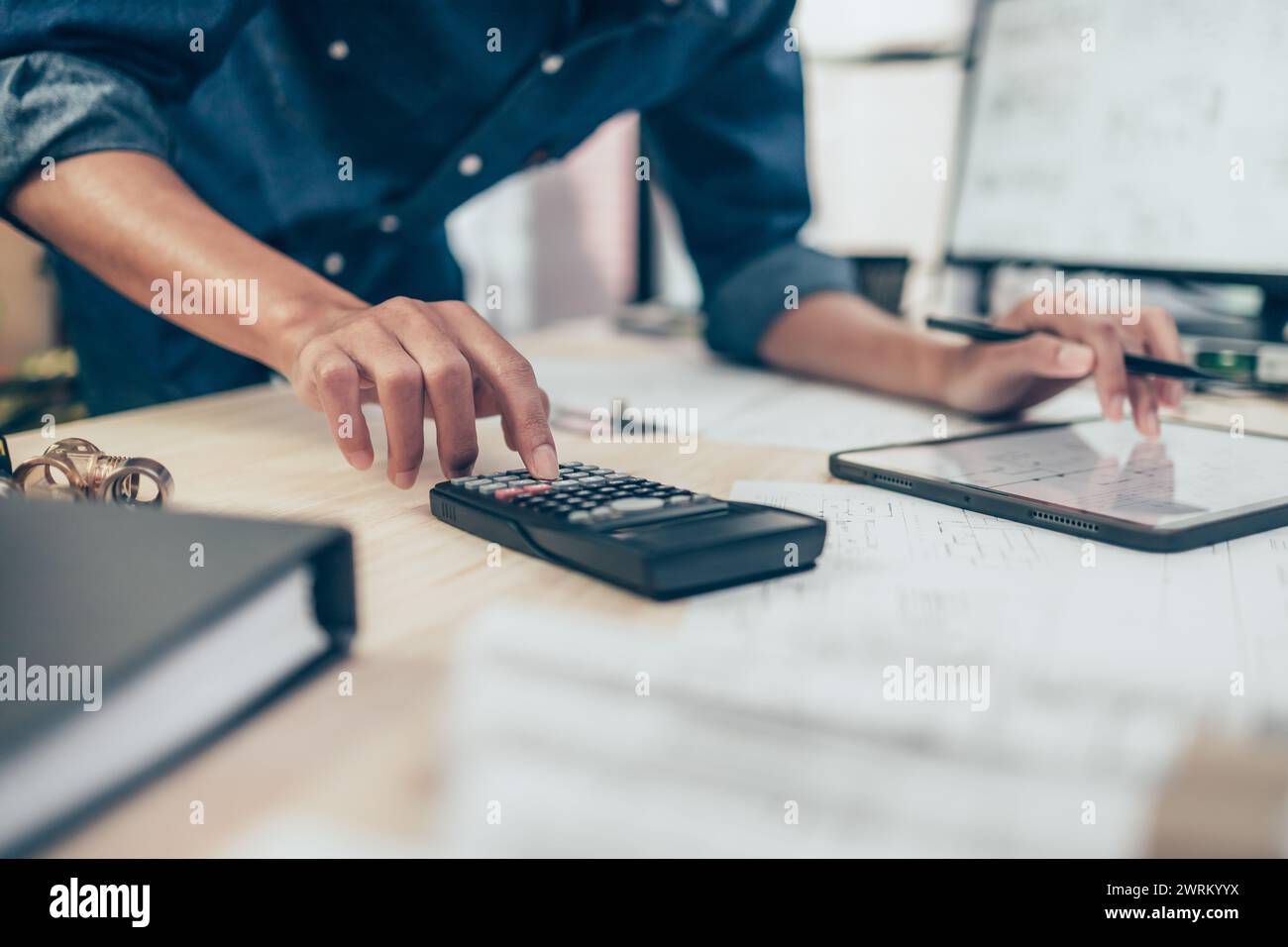 Architect engineer use calculator for calculate drawing design working ...