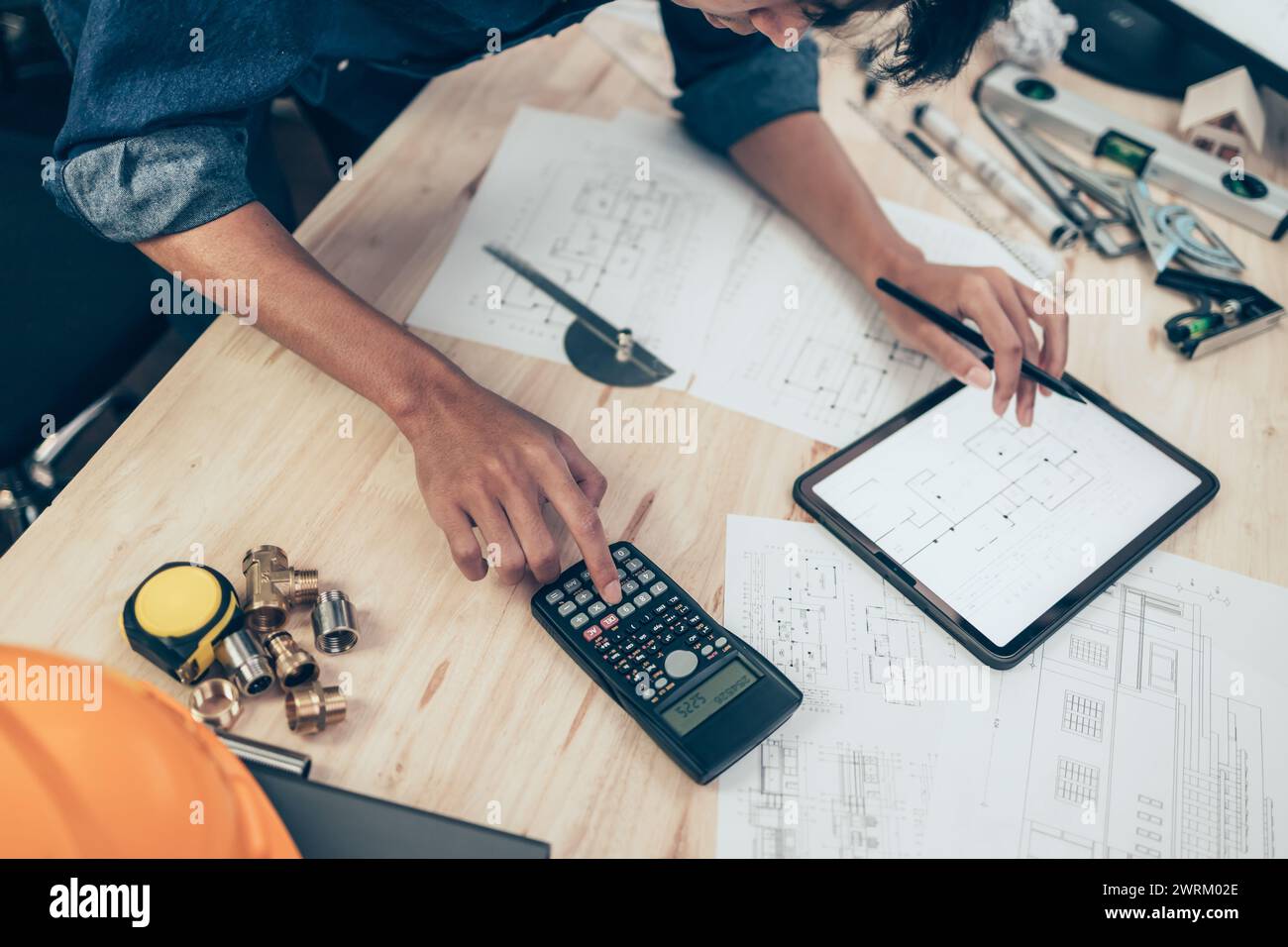 Architect engineer use calculator for calculate drawing design working ...