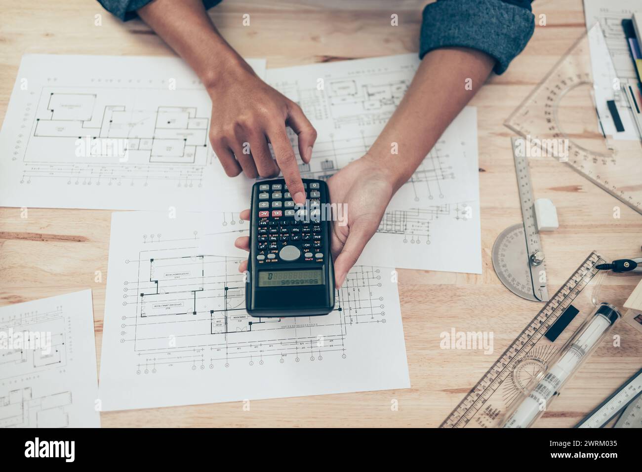 Architect engineer use calculator for calculate drawing design working ...