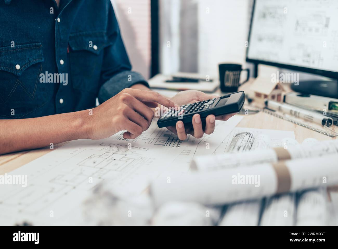 Architect engineer use calculator for calculate drawing design working ...