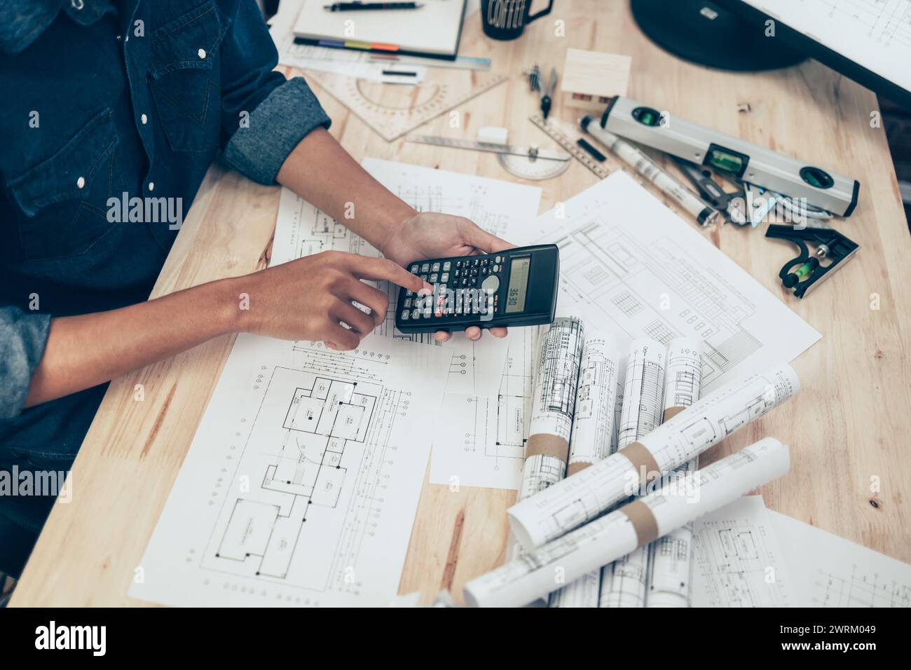 Architect engineer use calculator for calculate drawing design working ...