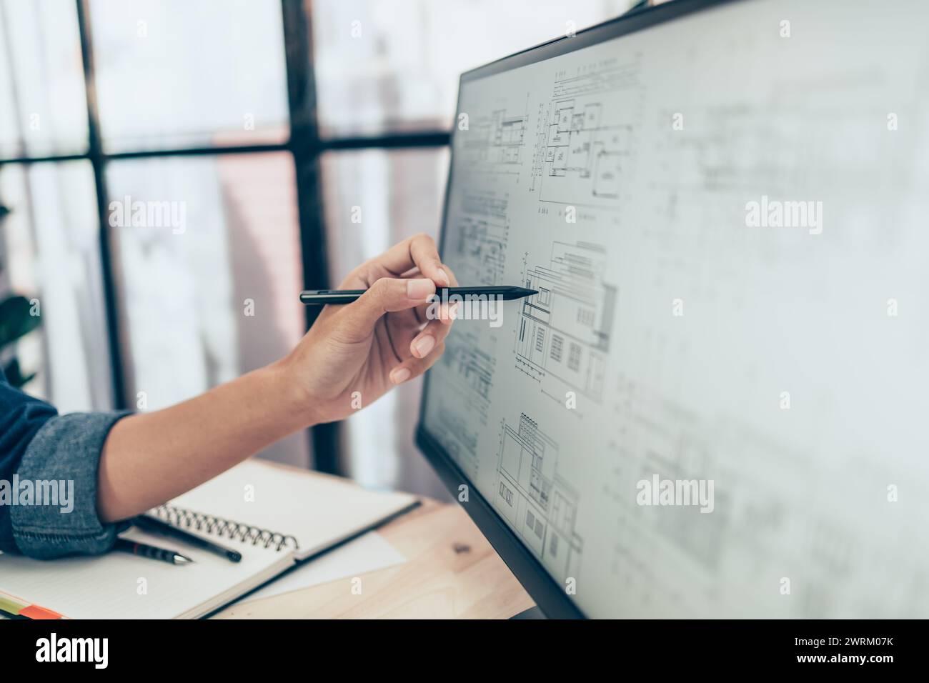Architect engineer read drawing design and hand pointing to monitor ...