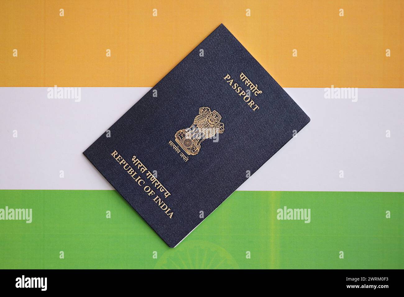 Blue Indian passport on national flag background close up. Tourism and ...