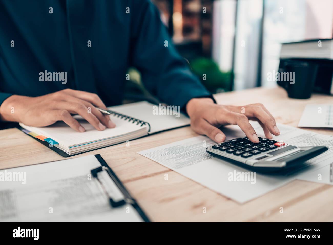 Investors working on desk office and using a calculator to calculate ...